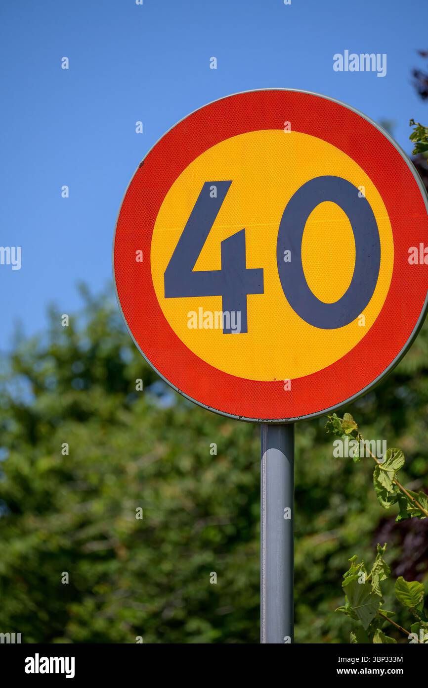 A circular speed limit sign displaying the number 40 stands prominently ...