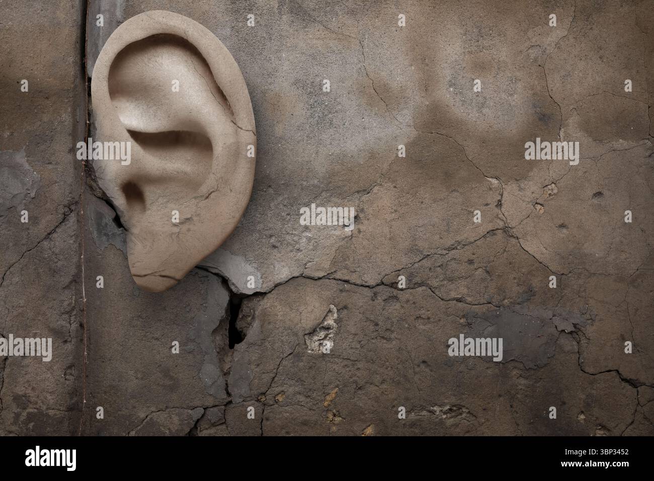 Human ear in old stone wall. Eavesdropping, concept that even walls ...