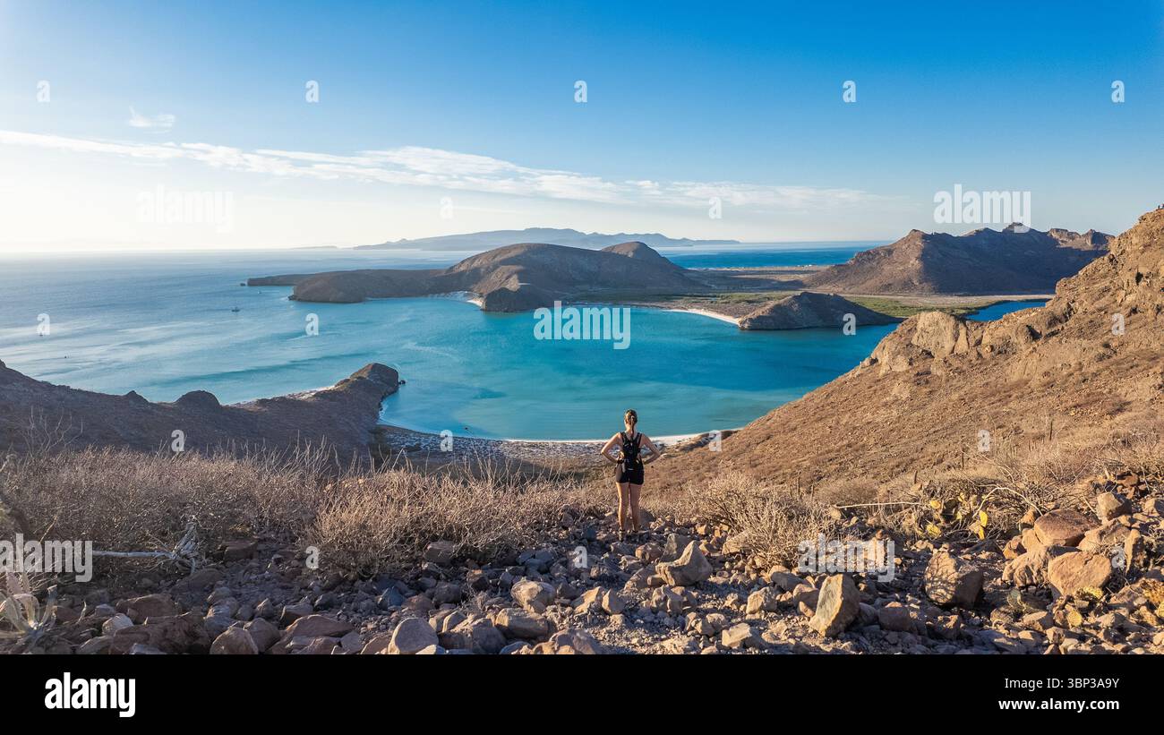 A scenic view from the cliffs above Balandra Beach at sunset, located ...