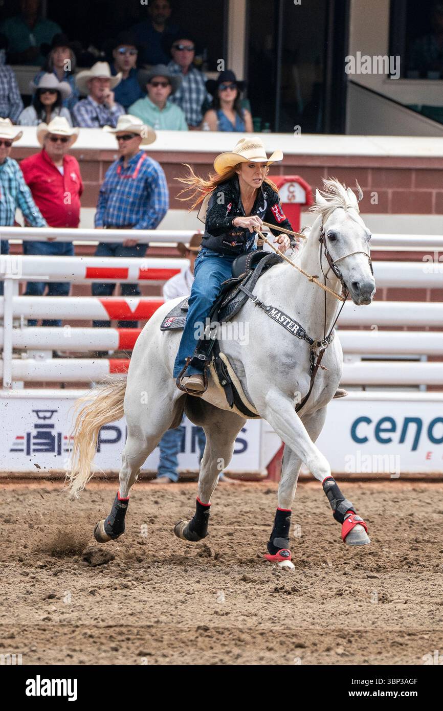 Cowgirlss compete in Female Barrel Racing during the Calgary Stampede ...