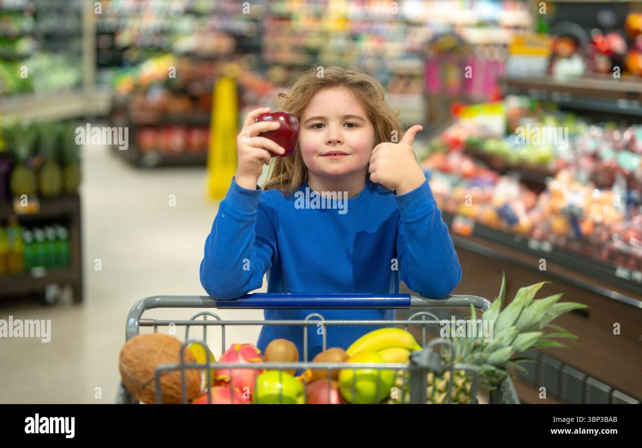 Child shopping in grocery store. Kid in supermarket. Child with ...