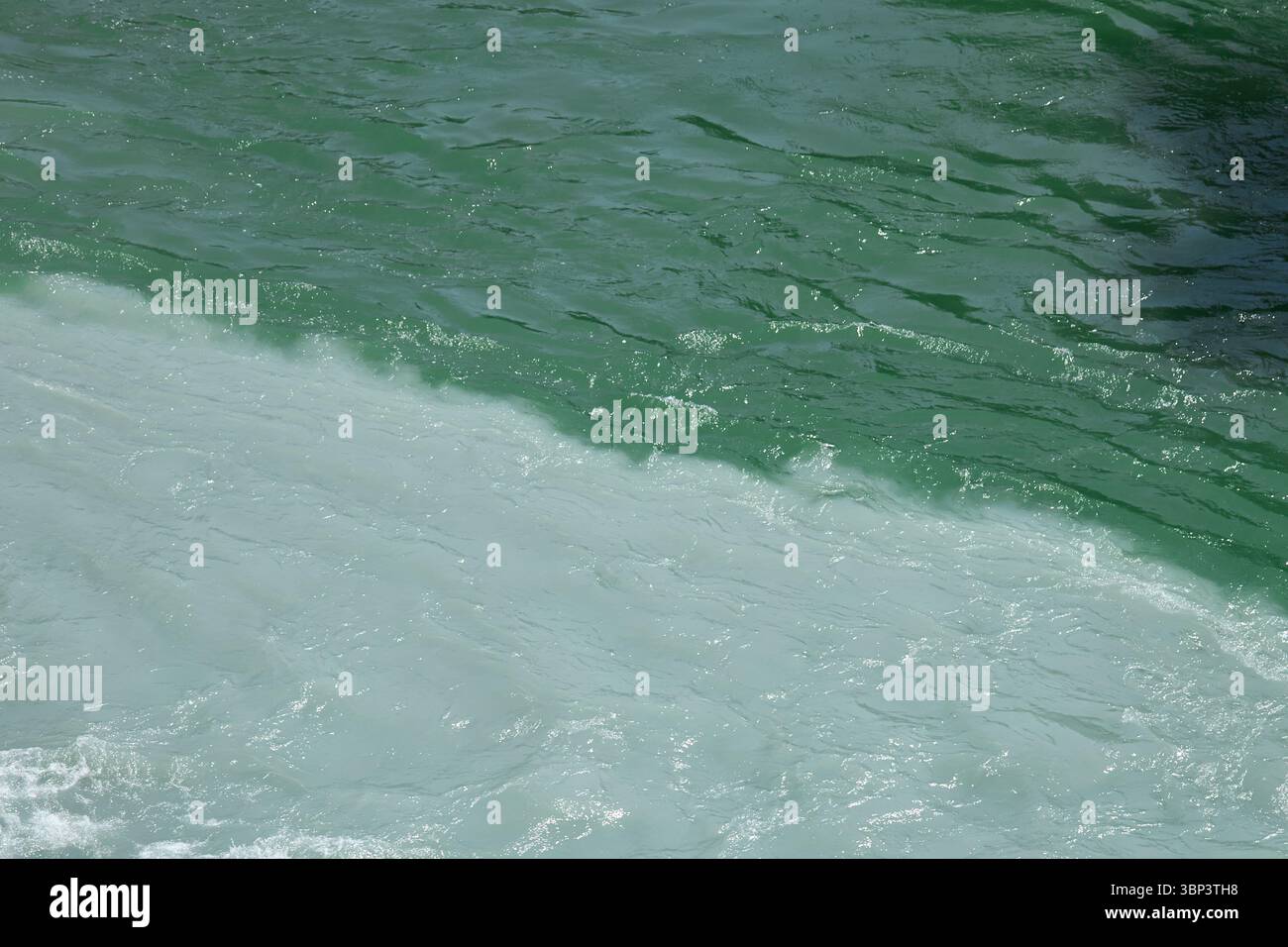 confluence of two rivers of different colors, emerald green and ...