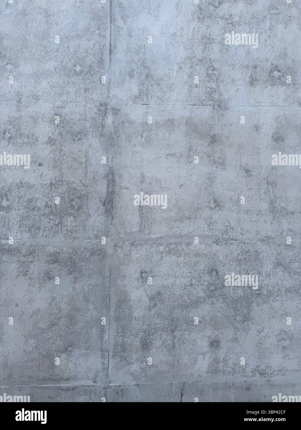 The image shows a close-up of a raw grey concrete wall. The surface ...