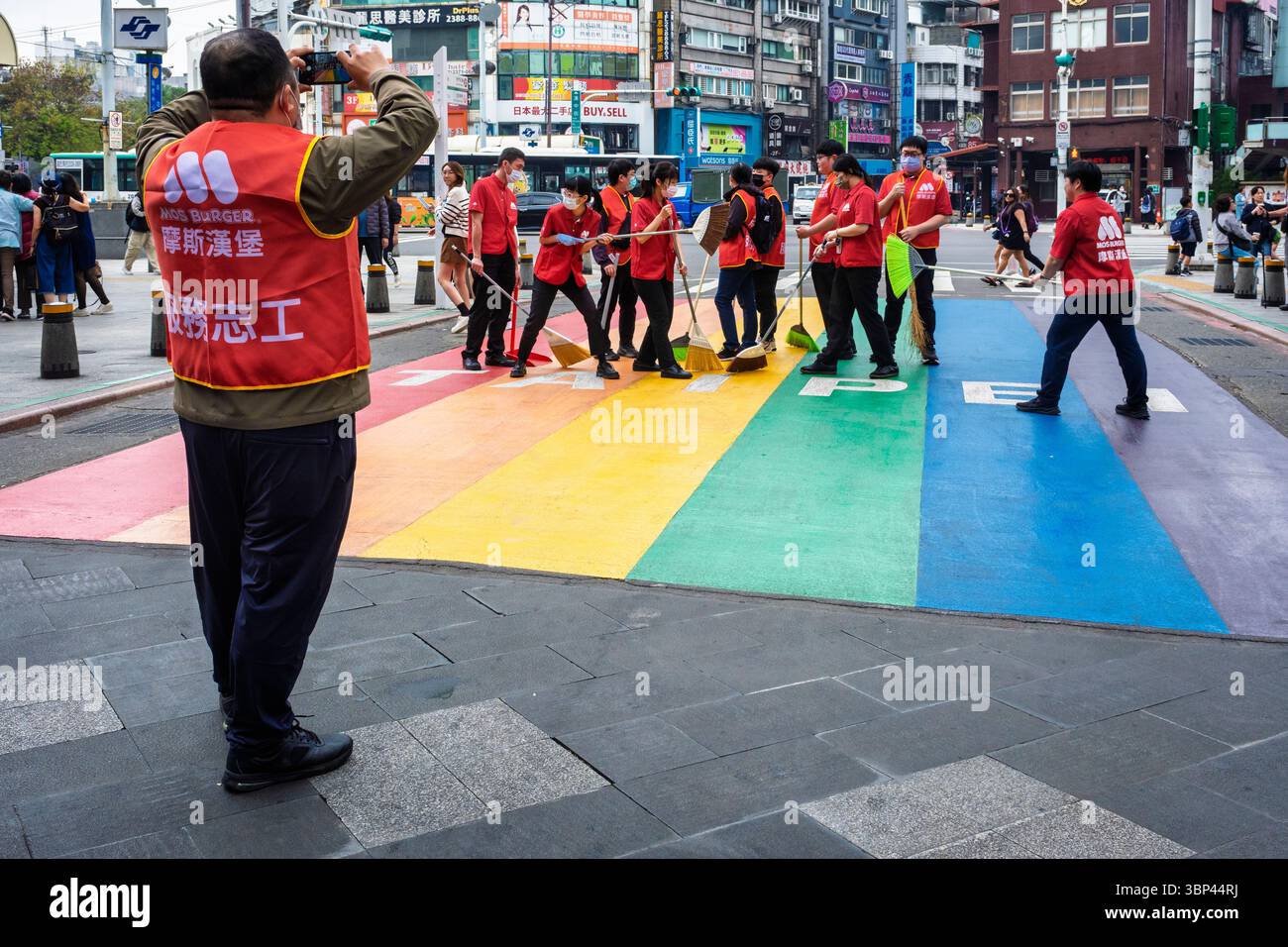 Staff from a Japanese burger chain pose for a photo at Rainbow Six, the famous rainbow crosswalk ...