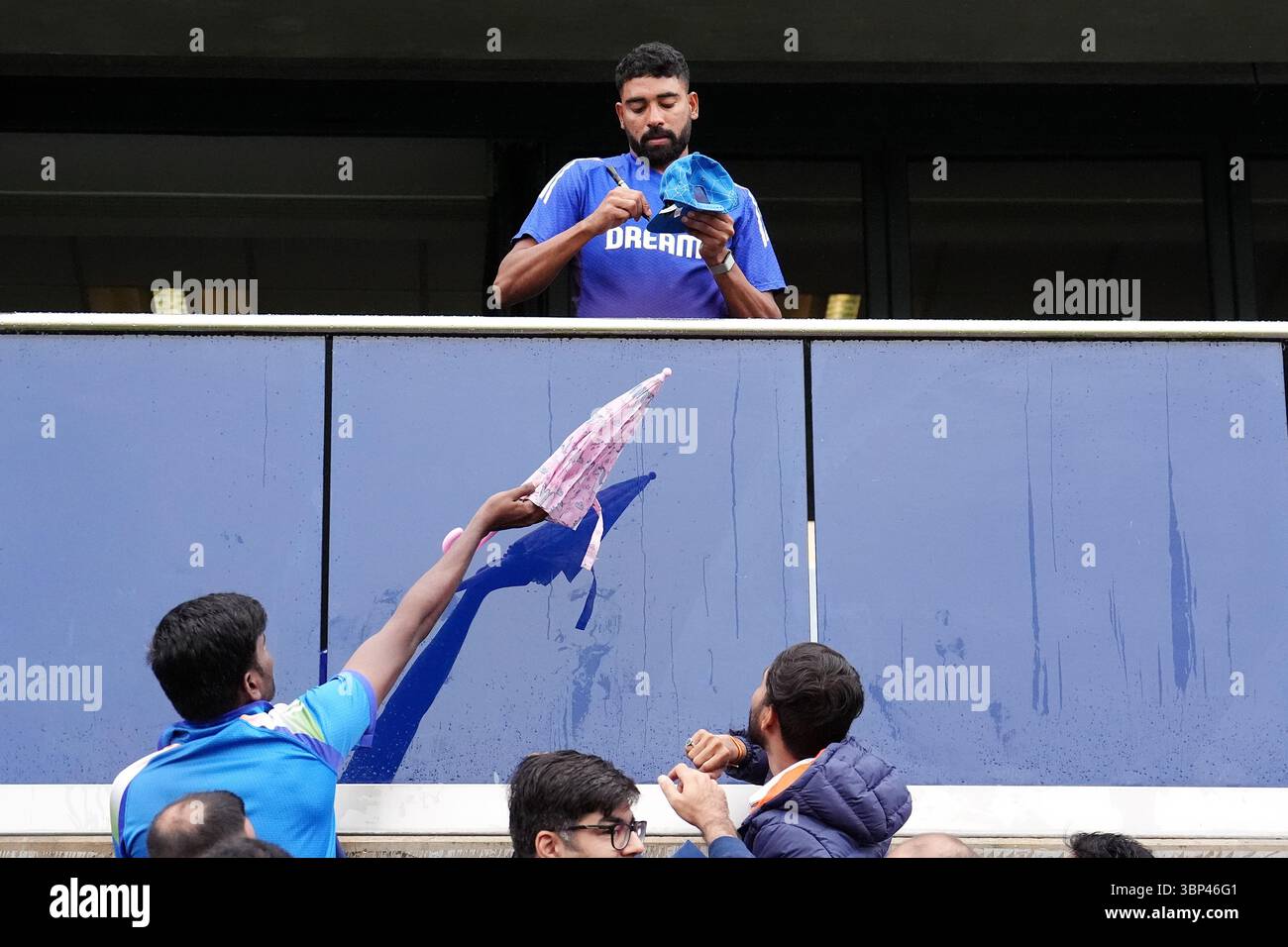 India's Jasprit Bumrah signs autographs during a rain delay on day five ...