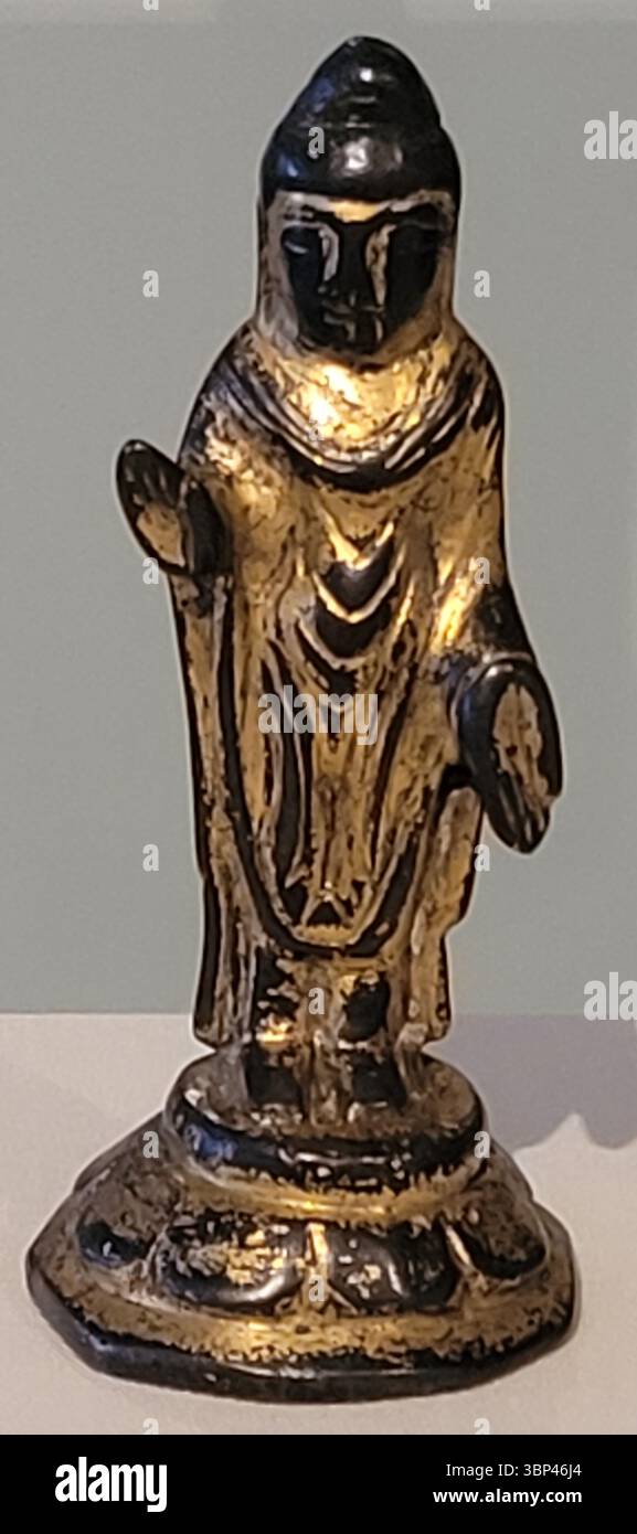 A close-up photograph of an ancient Korean Gilt-bronze Standing Buddha ...