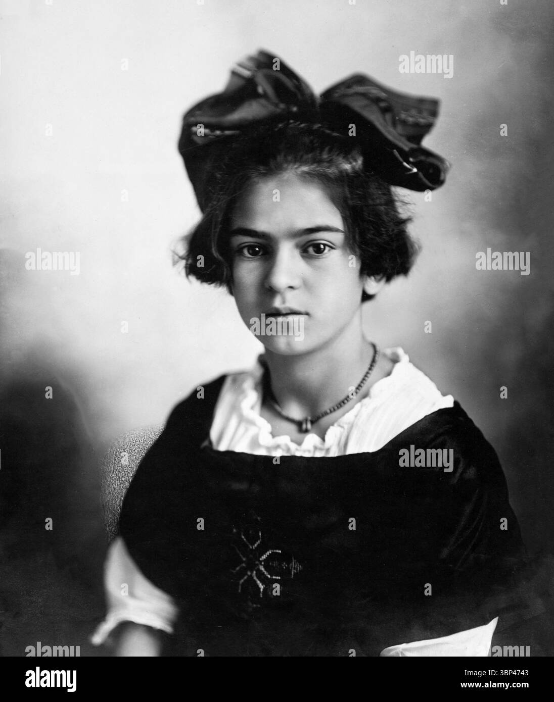 A black and white portrait photograph of a young Frida Kahlo, taken by ...