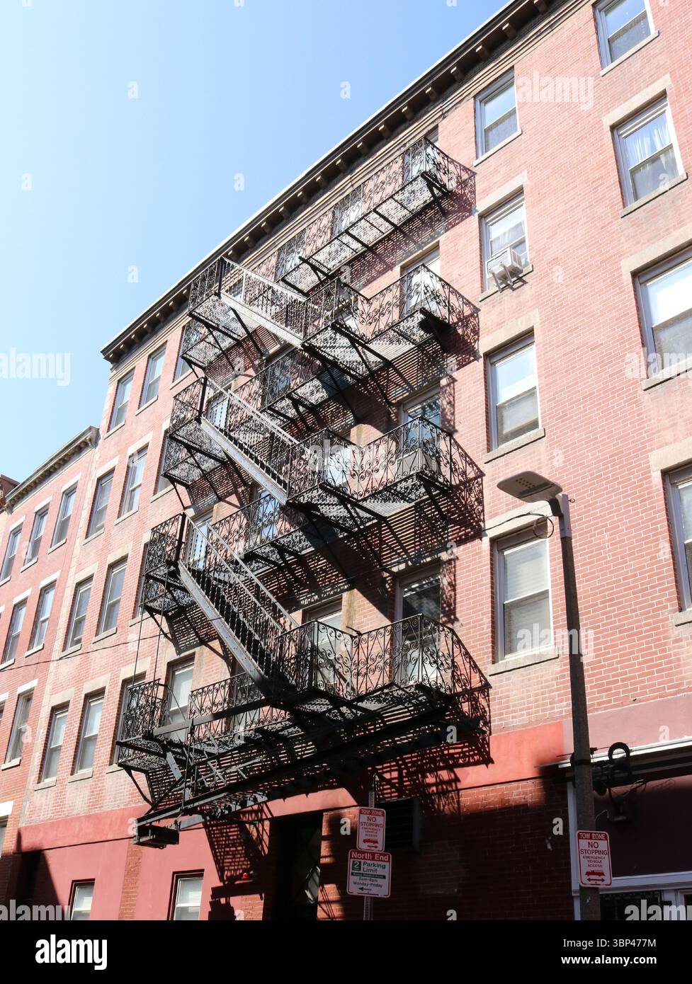 A photograph of red-brick tenement buildings in Boston, Massachusetts ...