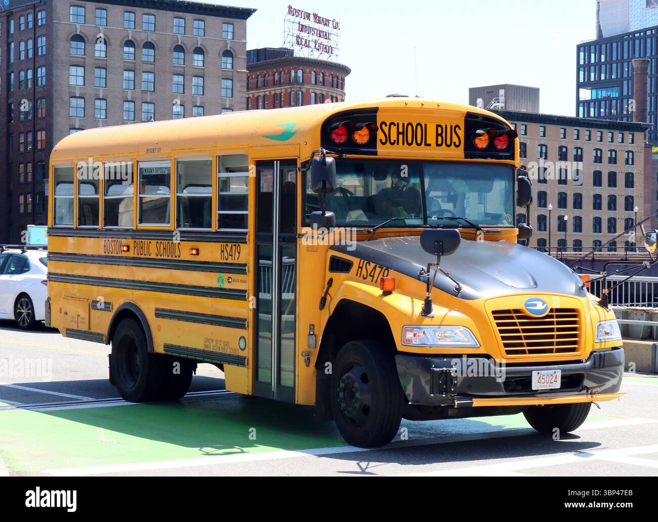 A photograph of a Boston Yellow school bus on a city street in Boston ...