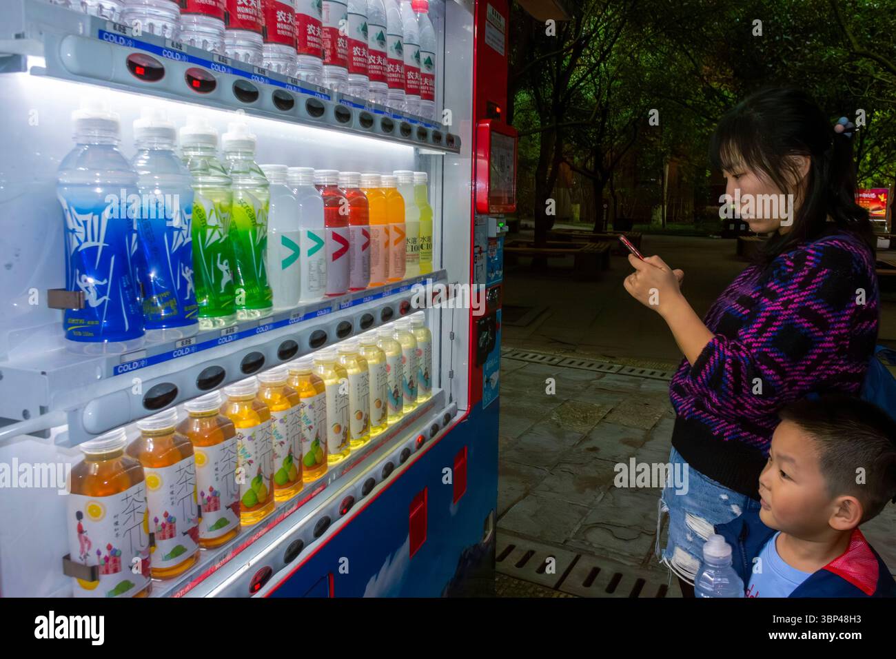 LeShan, China, Chinese Mum Buying Drinks for SOn from Outside Soda ...