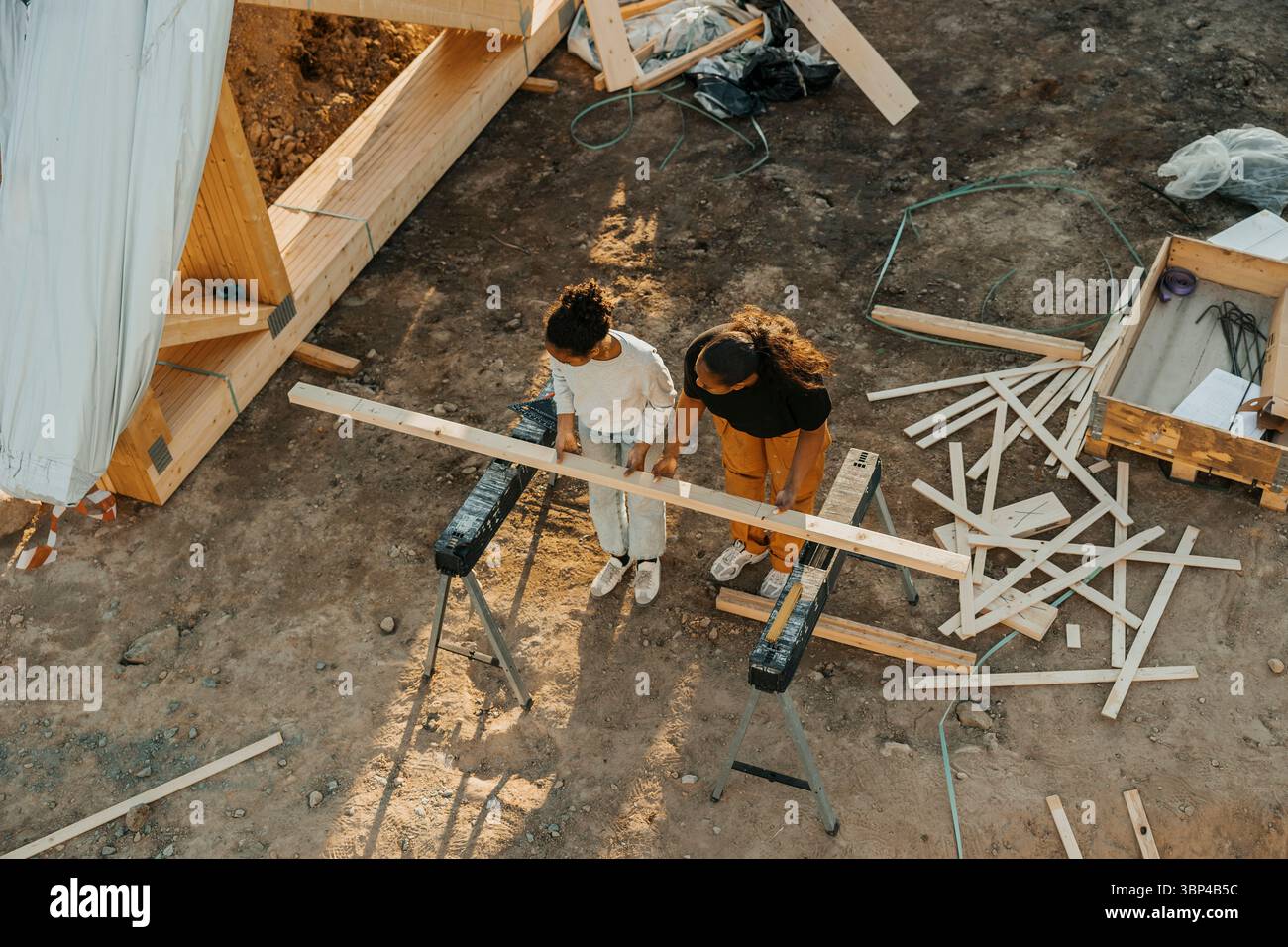 High angle view of mother and daughter working in back yard during ...