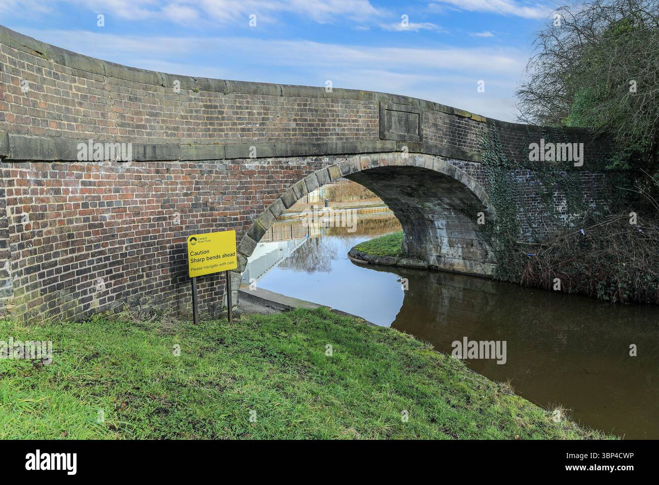 A sign on a bridge saying "caution sharp bends ahead" on the ...