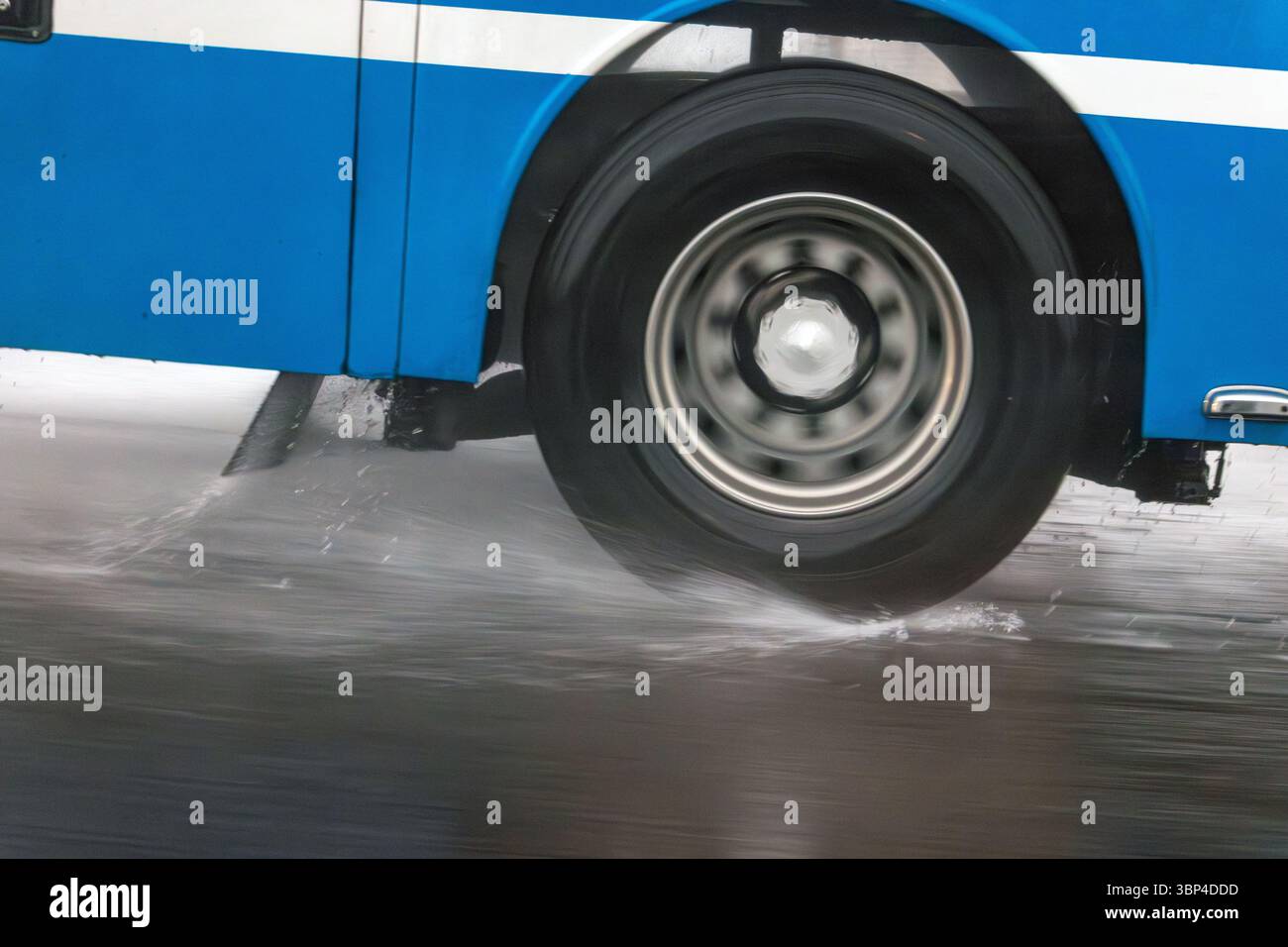 Detail of the wheel of a bus driving on a wet road during rain Stock ...