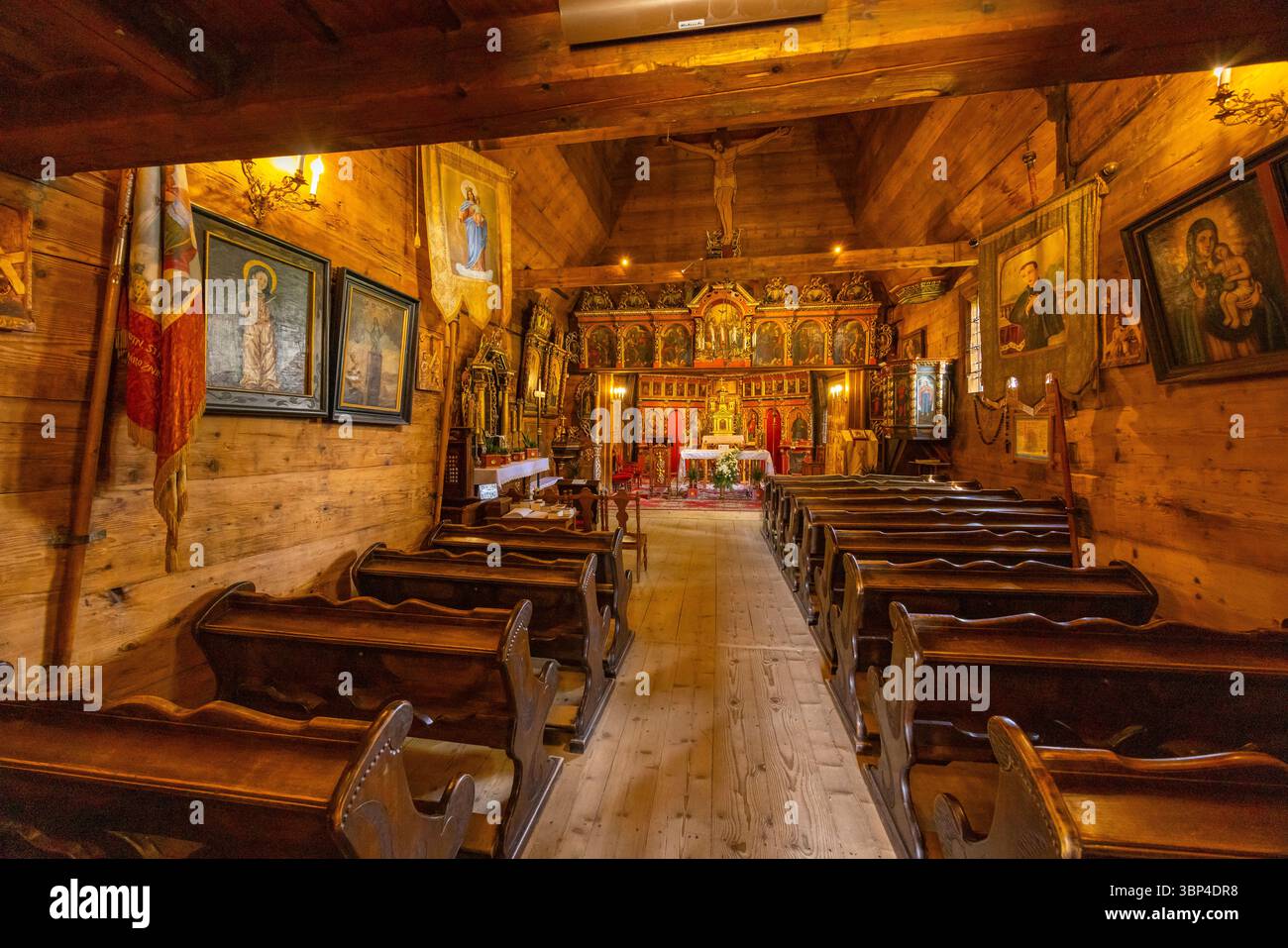 Wooden pews and altar inside a historic church in Muszyna, Poland Stock ...
