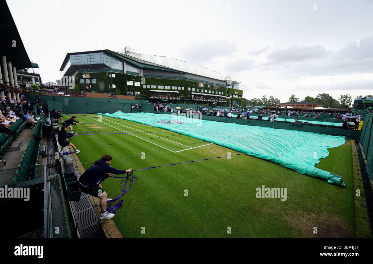 Ground staff cover court 4 as rain stops play on day seven of the 2025 ...