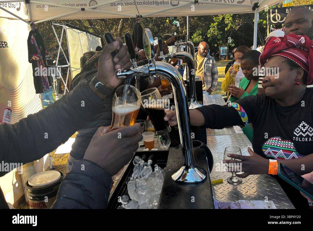 South African beer brewing master Apiwe Nxusani-Mawela serves customers ...