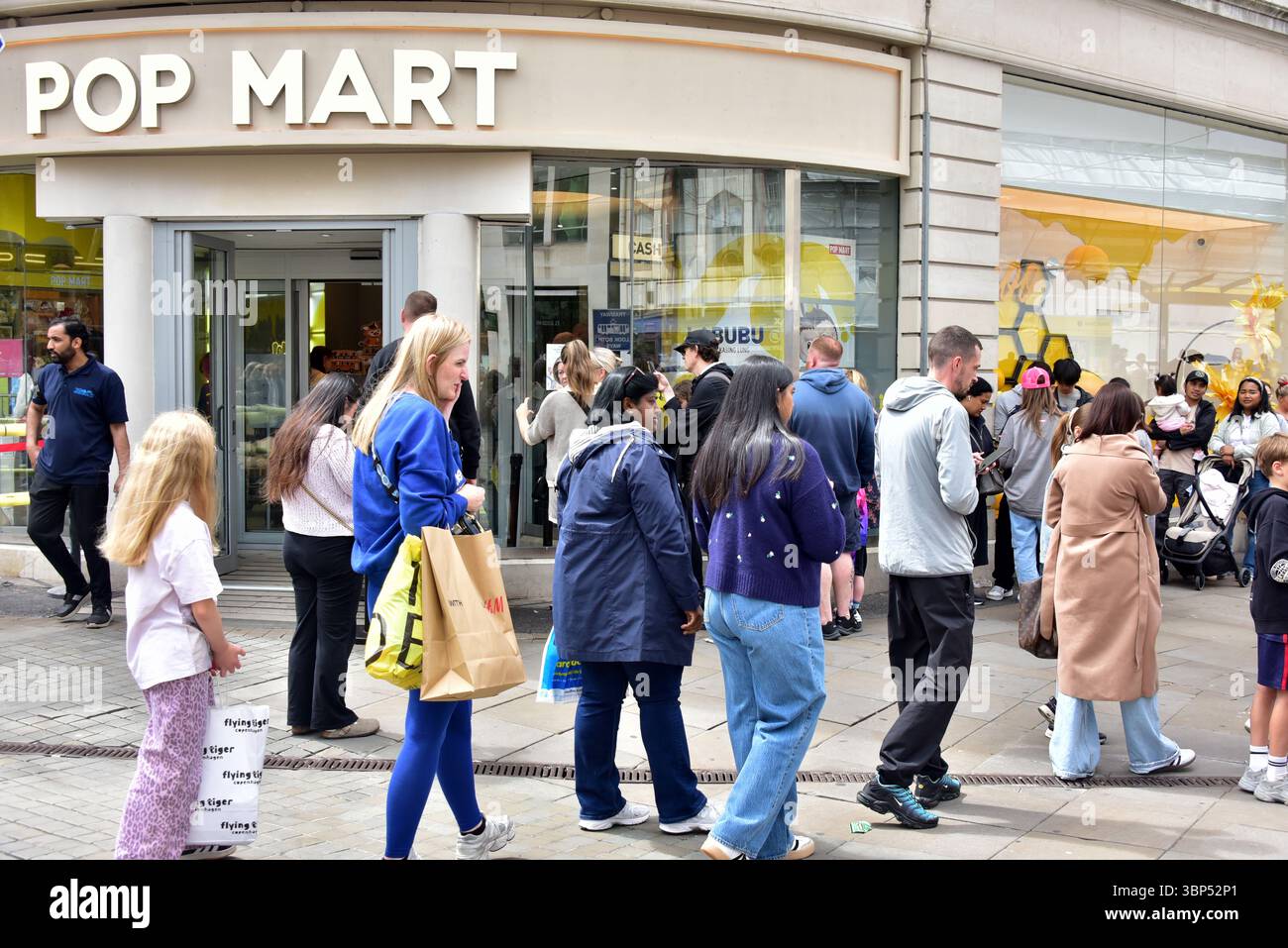 A large queue at the Pop Mart shop in Piccadilly, central Manchester ...