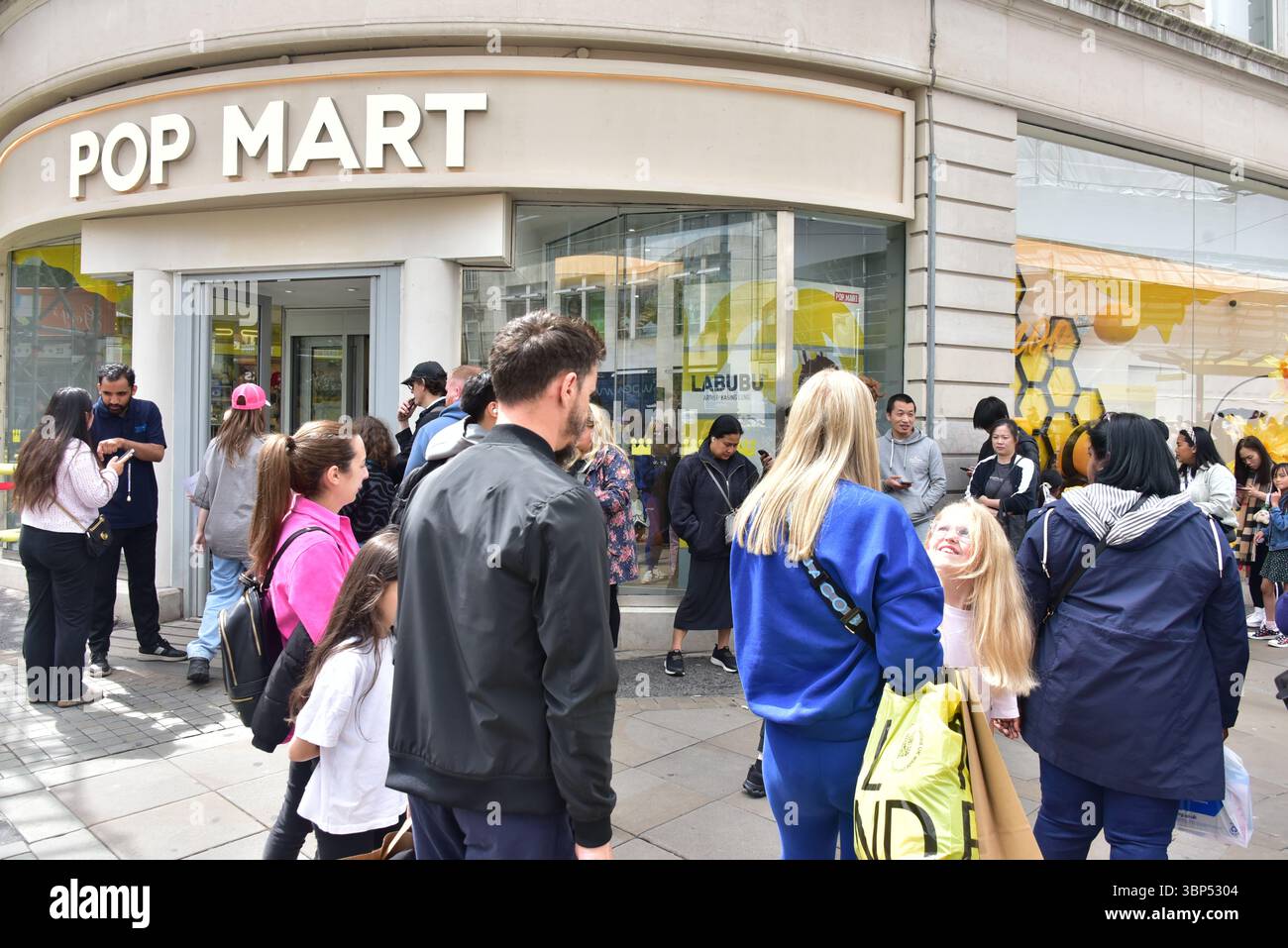 A large queue at the Pop Mart shop in Piccadilly, central Manchester ...