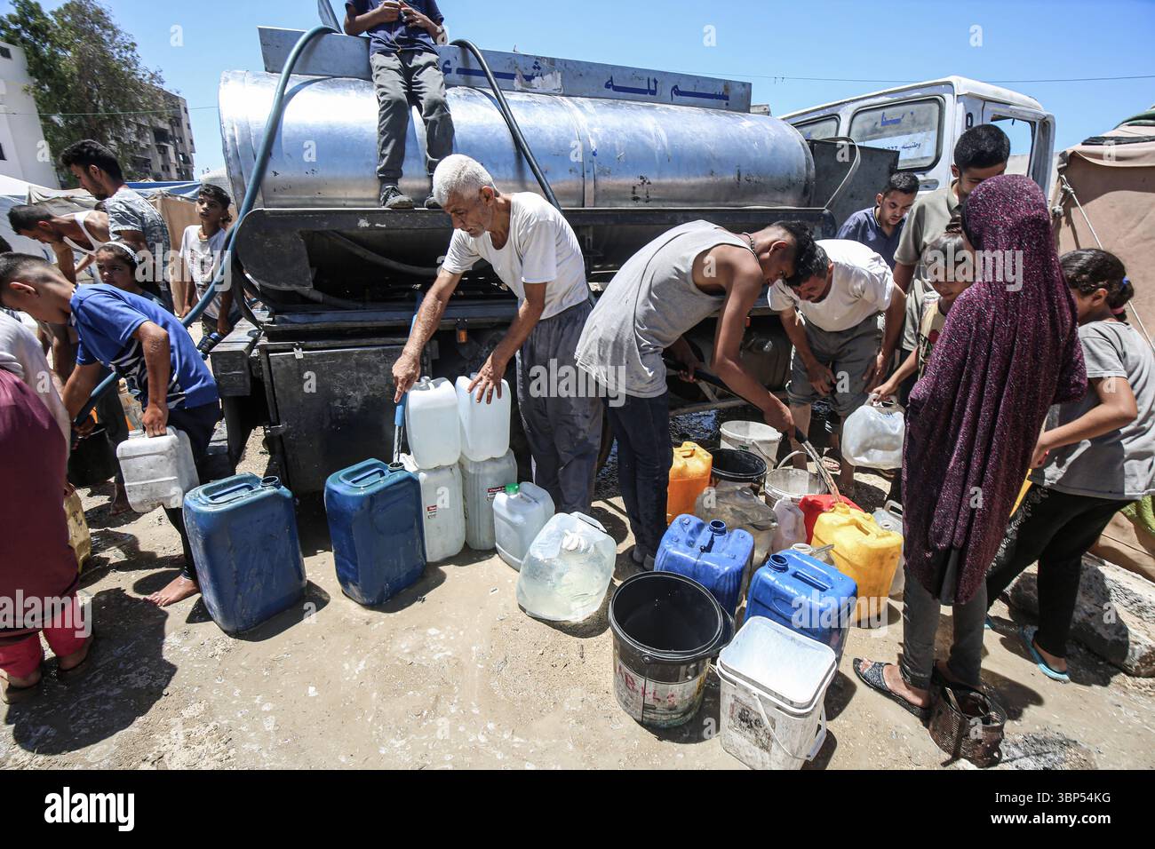 Palestinians try to meet their daily water needs by filling jerry cans ...