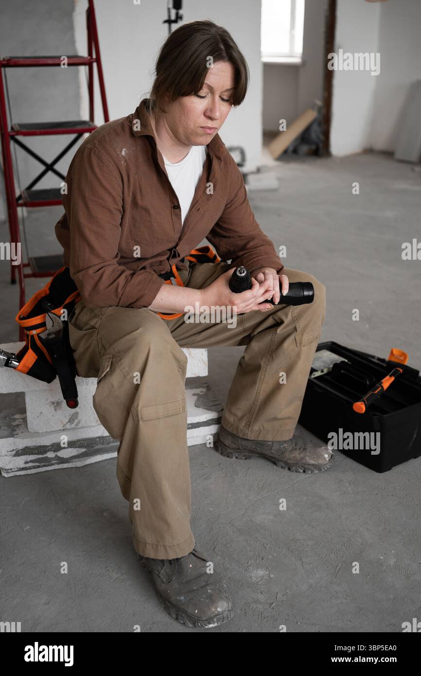 Female Handyman Resting at Home Sitting with Drill and Open Toolbox ...