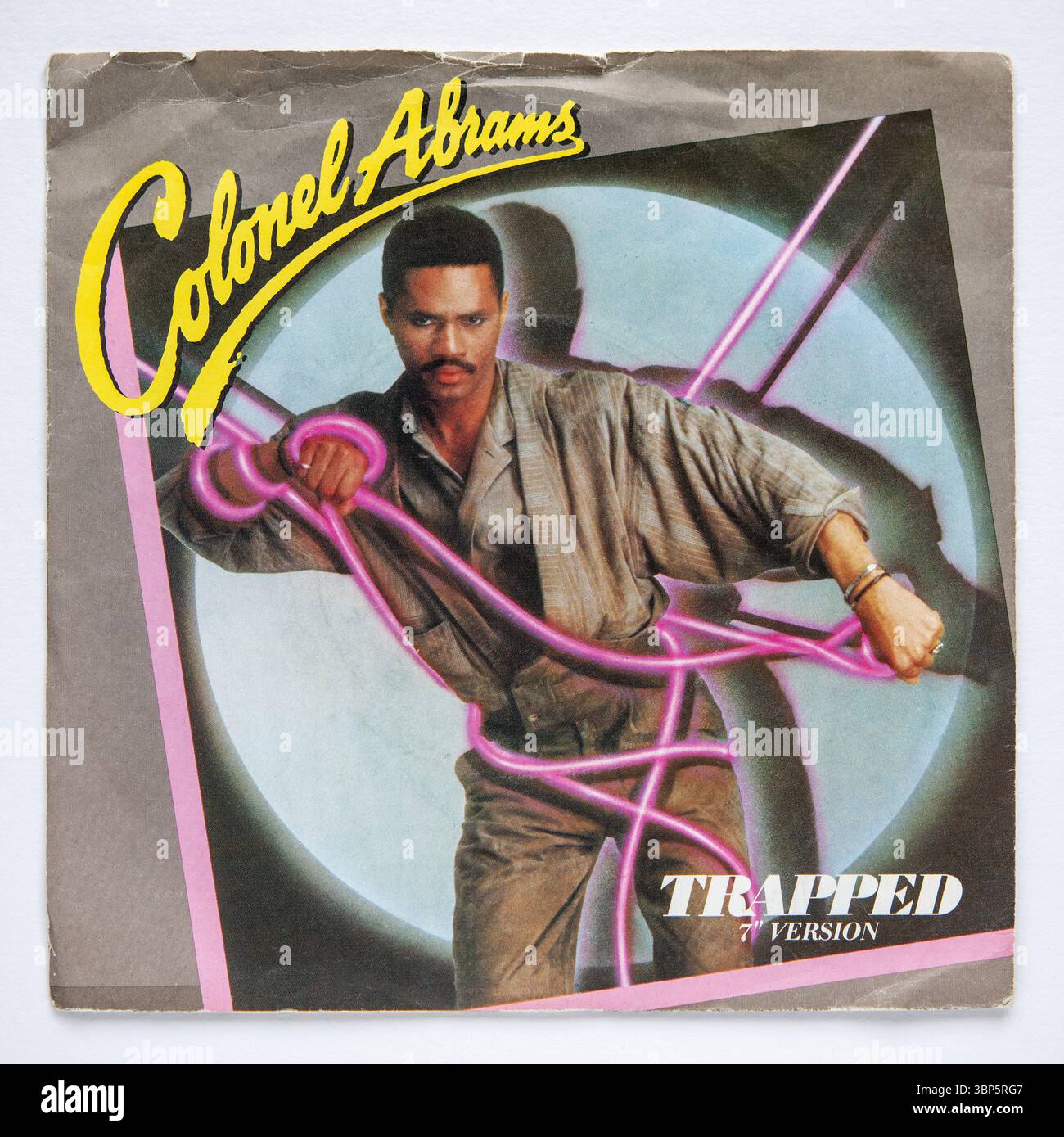 Picture cover of the seven inch single version of Trapped by Colonel ...