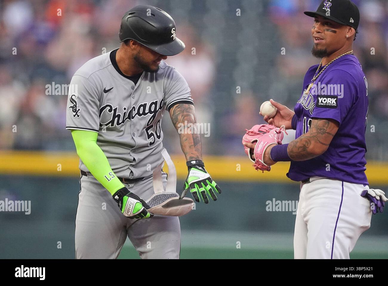 Chicago White Sox second baseman Lenyn Sosa (50) jokes with Colorado ...