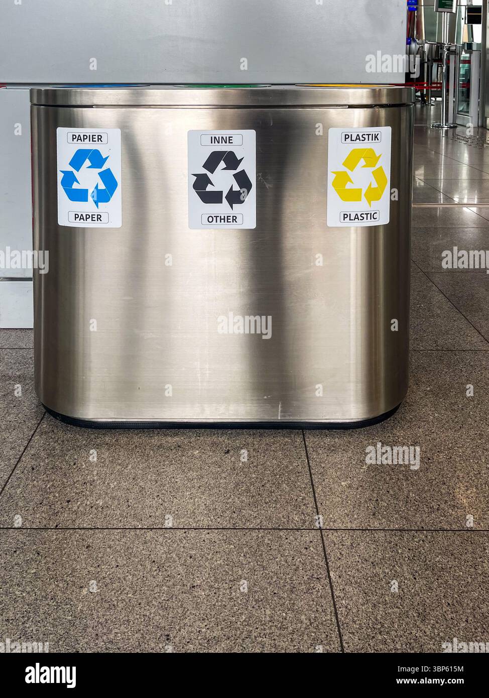 Recycling bin features three sections labeled for paper, plastic, and ...