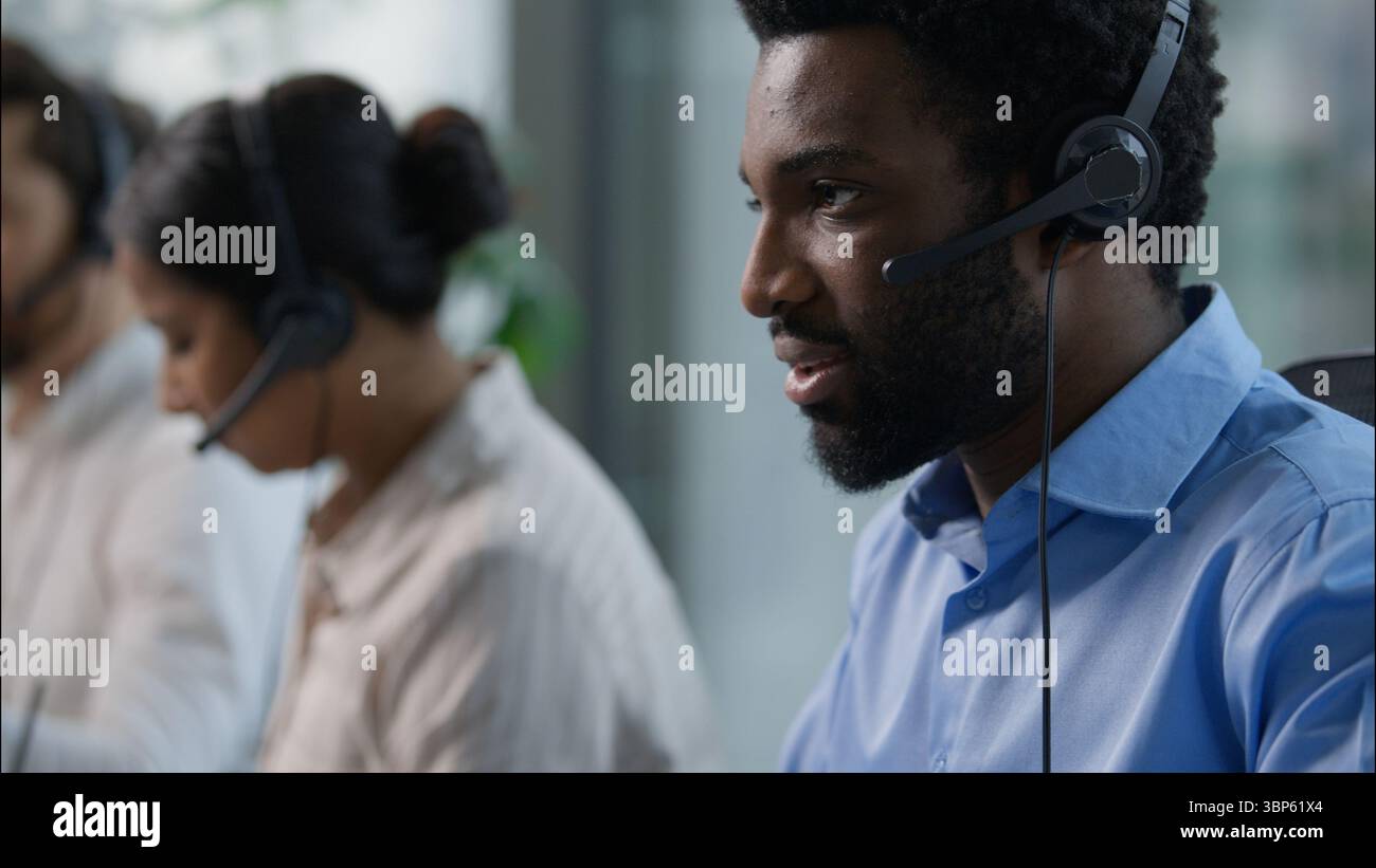 Call center helpline workers headset typing keyboard computer business service African American ...