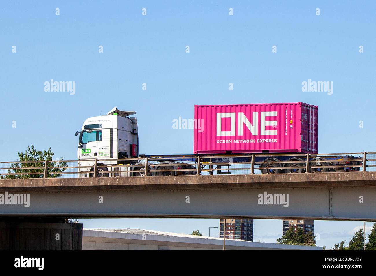 A white BCD Logistics DAF articulated flatbed truck transports a bright ...