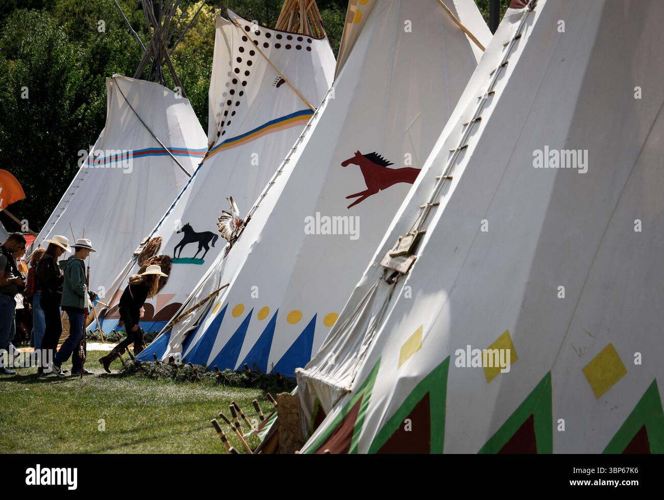 Visitors enter a teepee in the Elbow River Camp at the Calgary Stampede ...