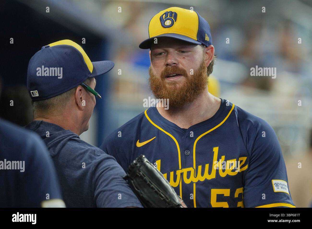 Milwaukee Brewers pitcher Brandon Woodruff (53) talks to a coach at the ...