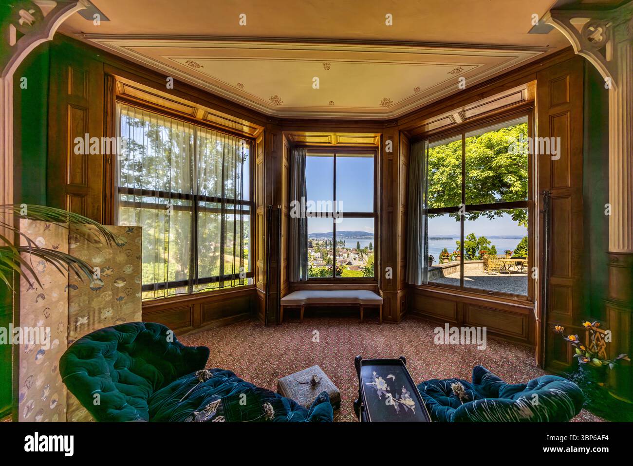 Interior of Arenenberg Castle with large panoramic windows and views of ...