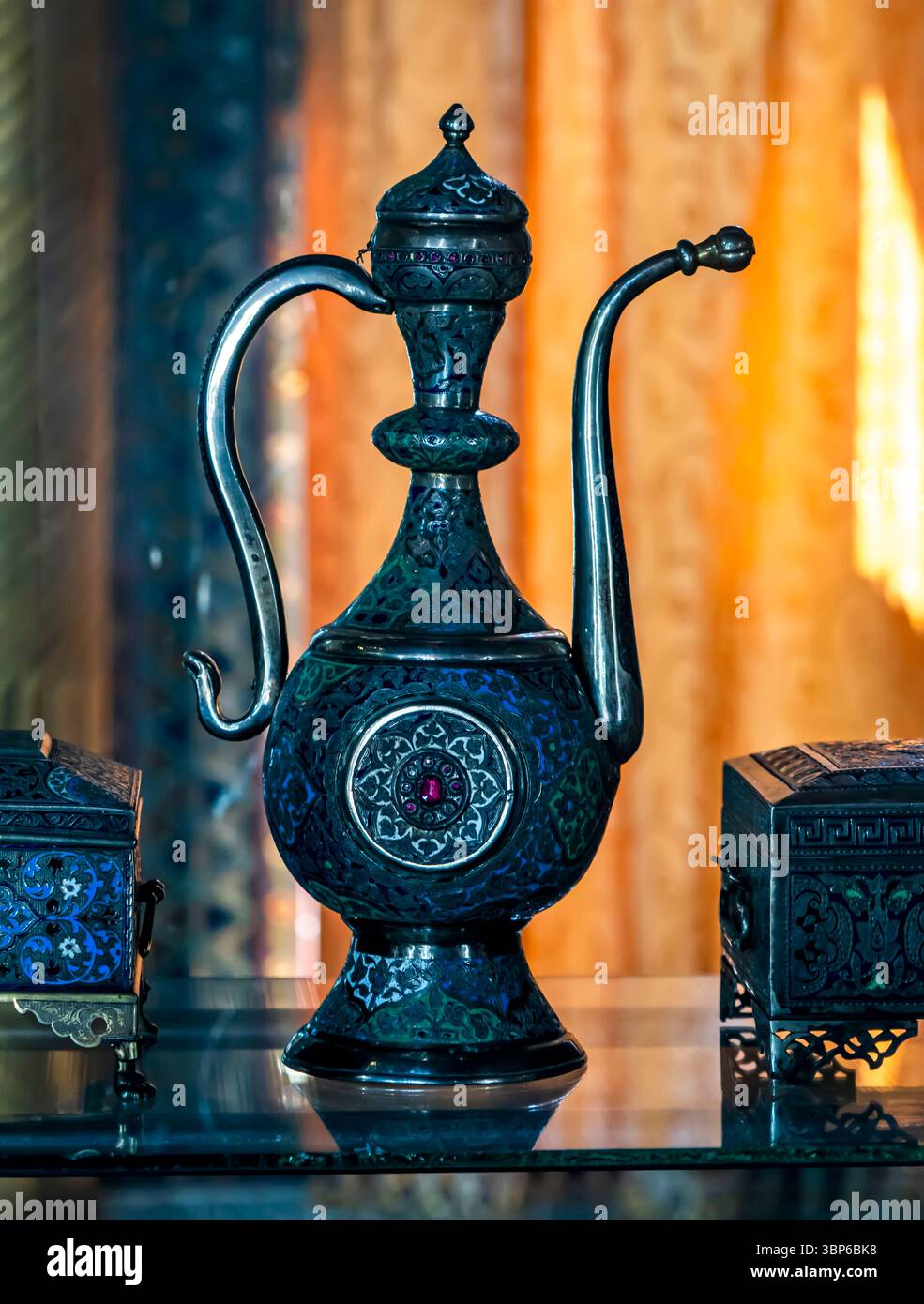 A beautifully crafted antique metal teapot with intricate engravings ...