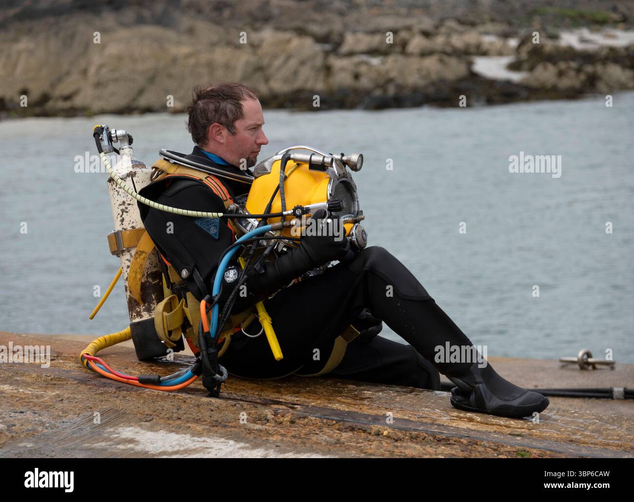 A commercial diver sitting during a break from repair work on the ...