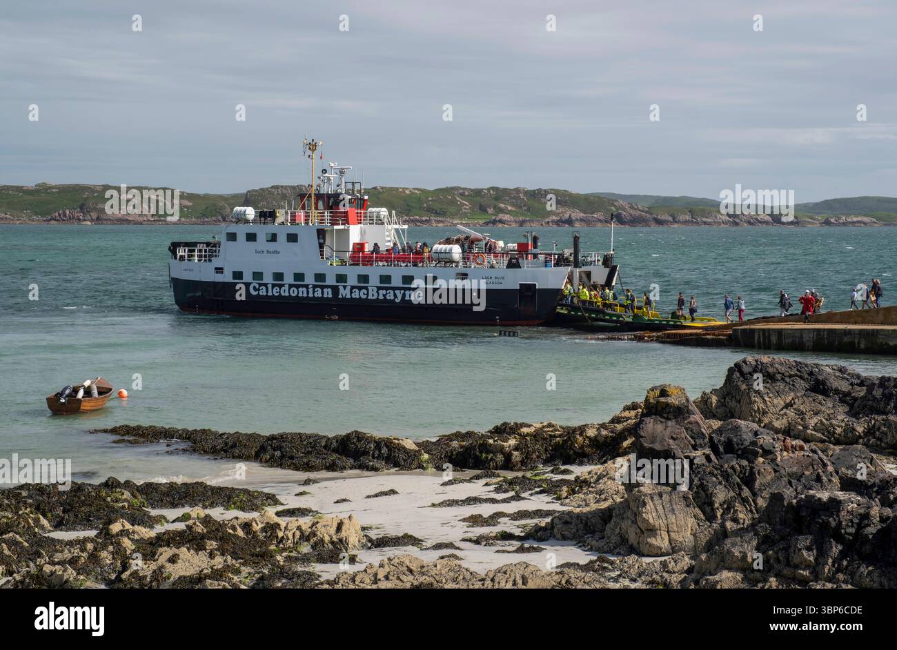 Passengers board the Caledonian MacBrayne ferry Loch Buie at Baile Mor ...