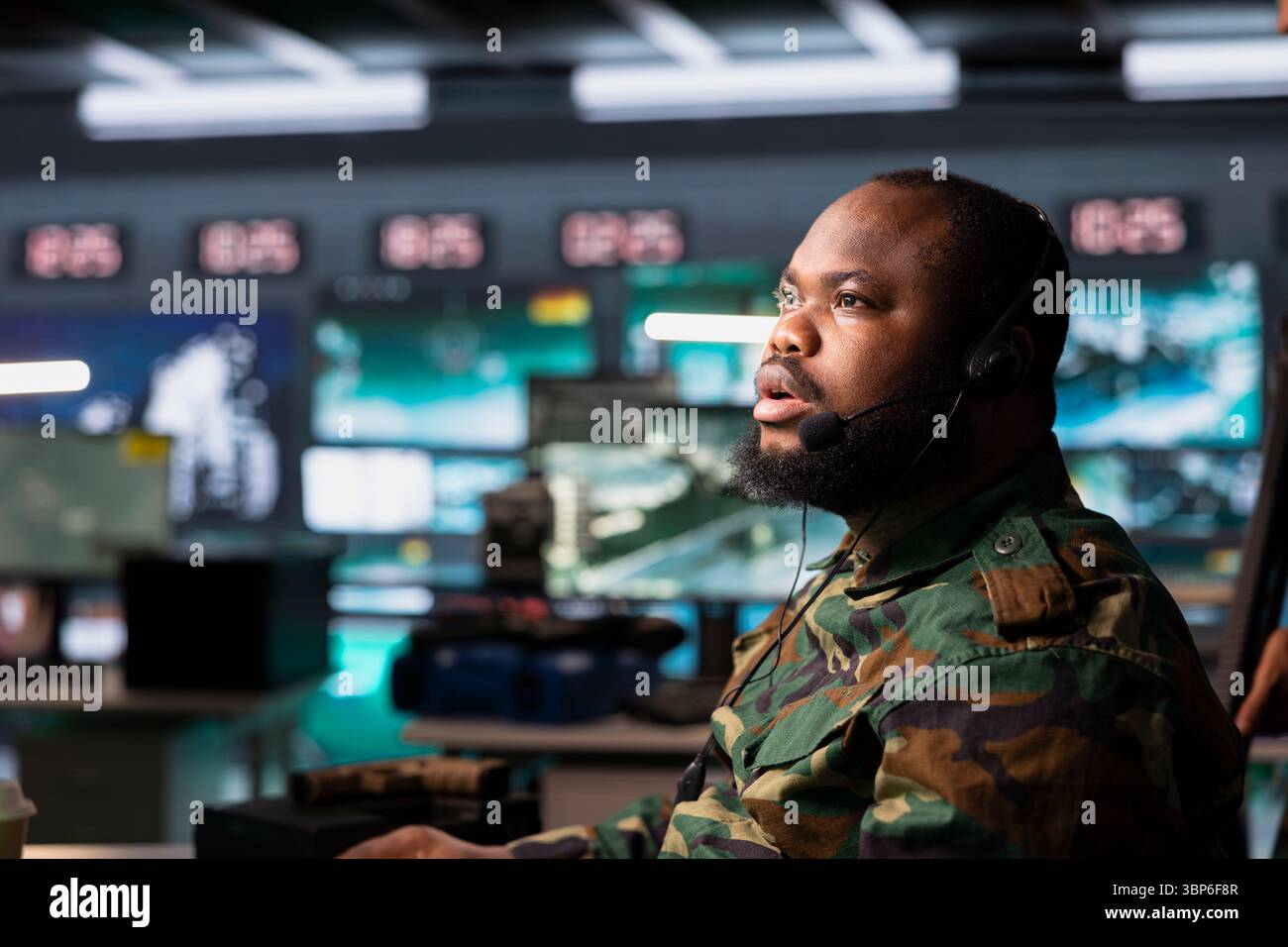 Military dispatcher using headphones microphone, offering information ...