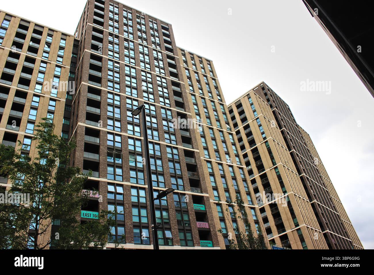 A sleek, glass-clad skyscraper with sharp angles and open spaces ...