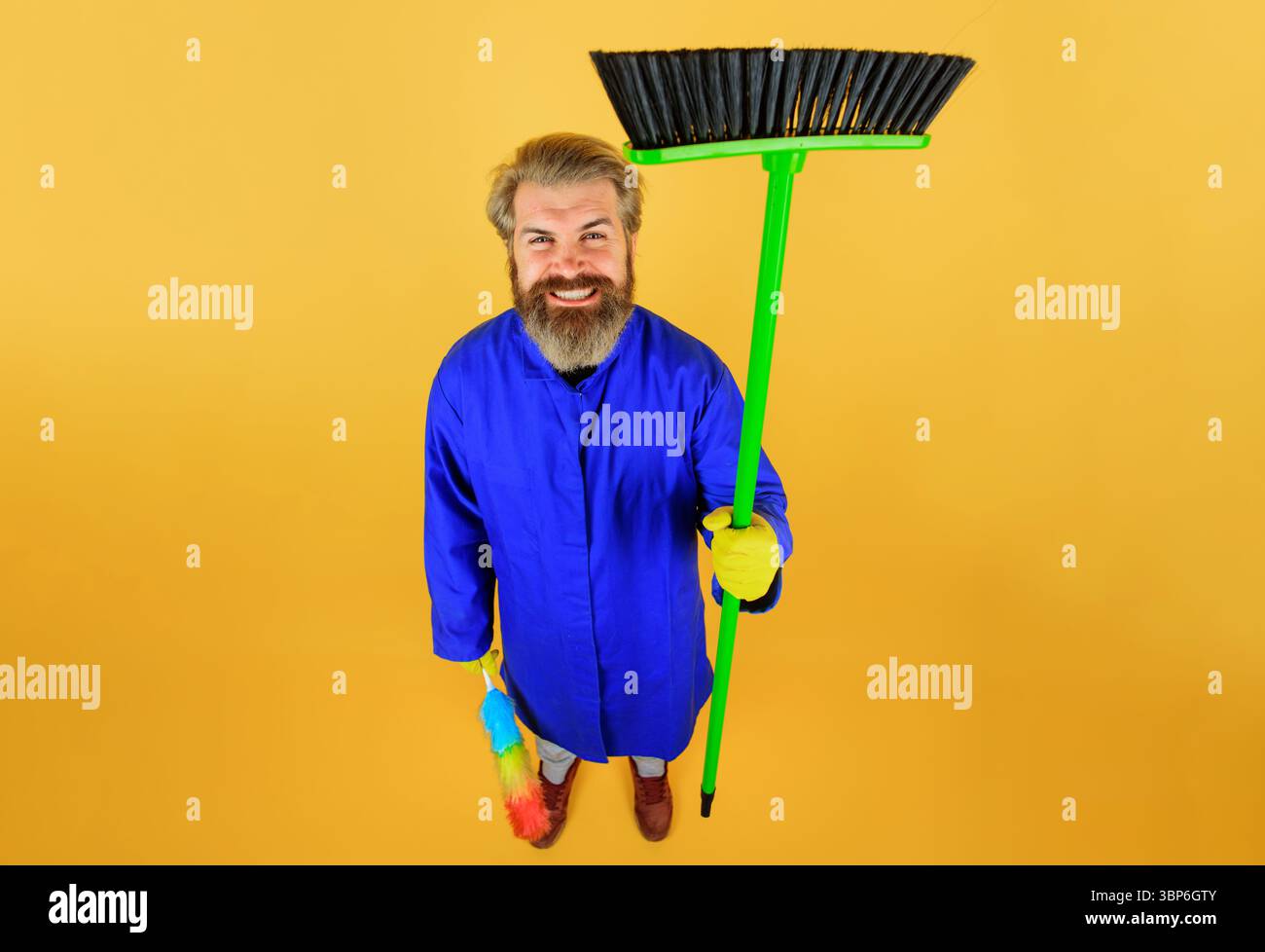 Cleaner man with broom. Professional cleaning service. Full length ...