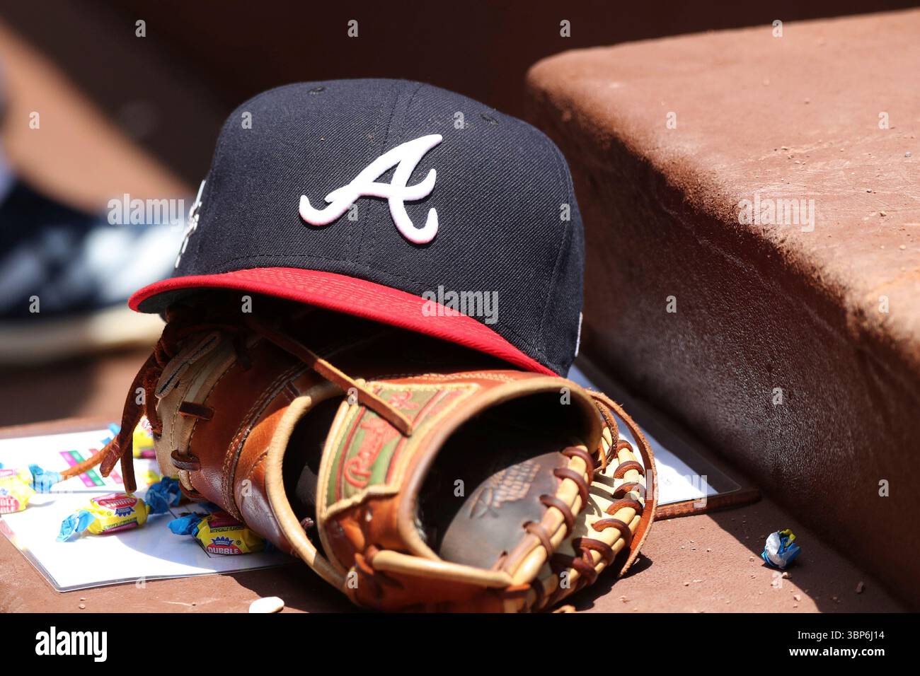 ATLANTA, GA - JULY 06: The baseball cap of the Atlanta Braves sits on ...