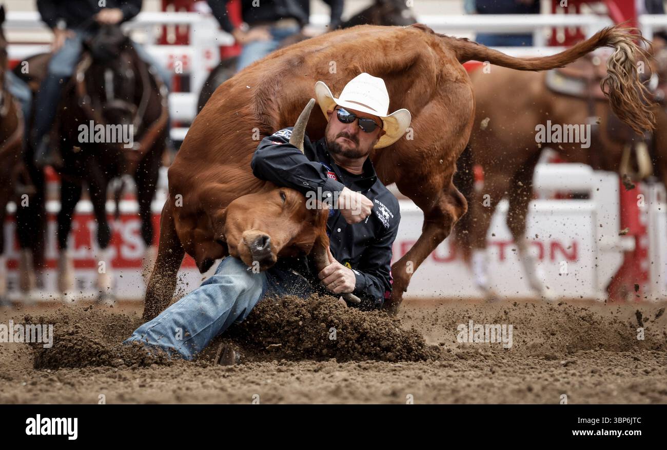 Kyle Irwin, of Robertsdale, Florida, competes during steer wrestling ...