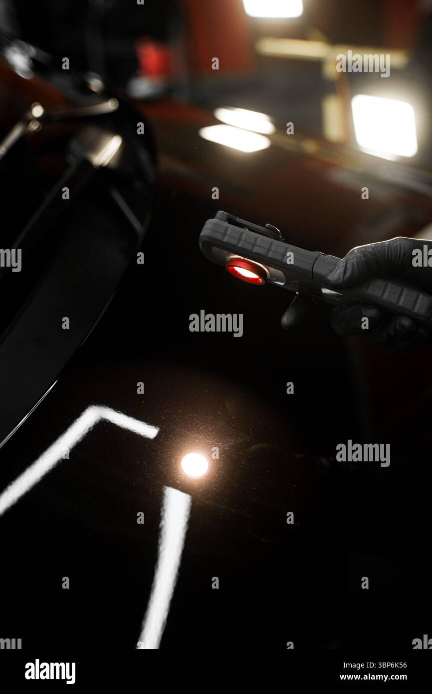 Swirl finder light to detect paint issues on black car in a detailing ...