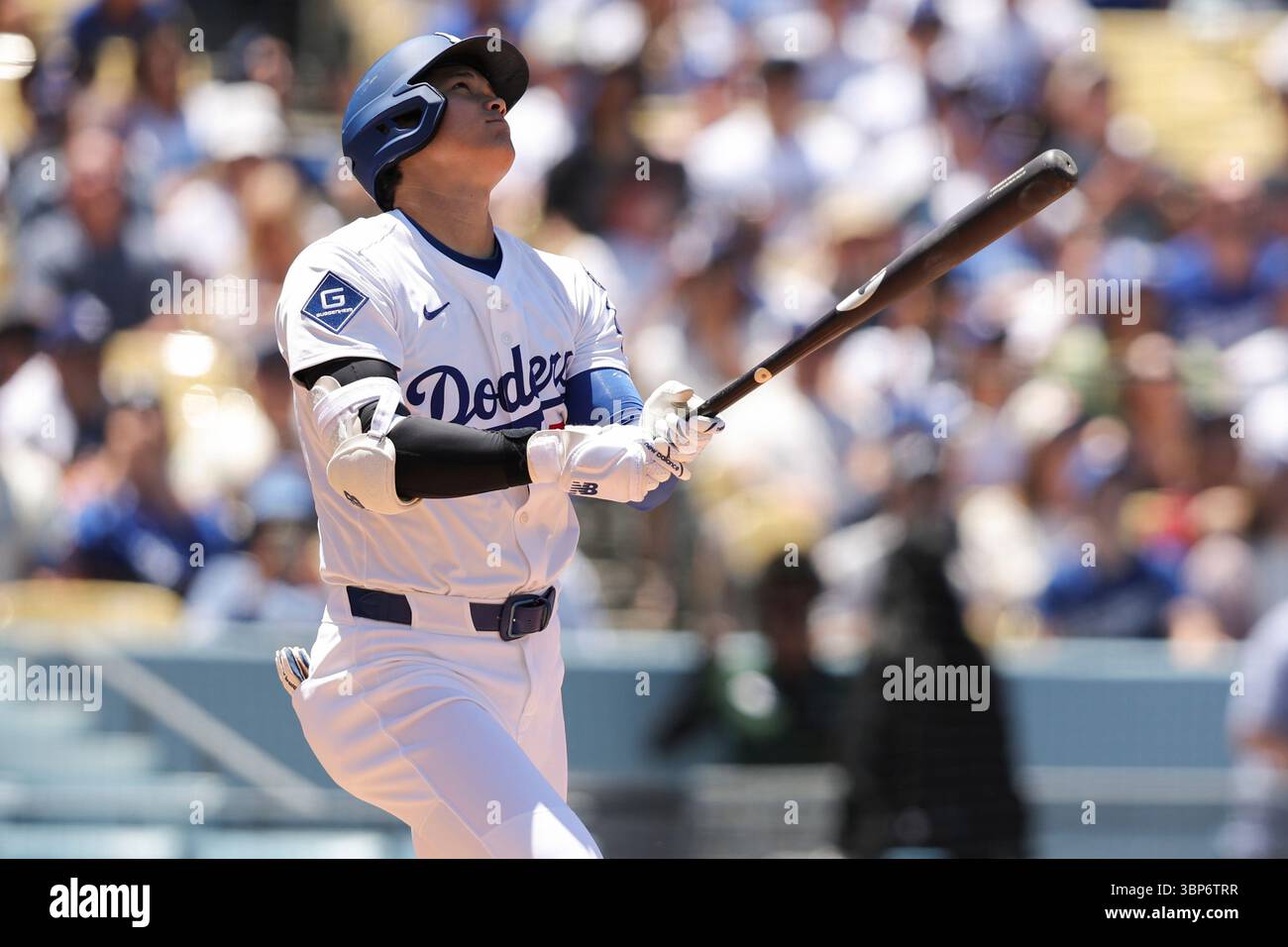 Los Angeles Dodgers designated hitter Shohei Ohtani watches his fly ...