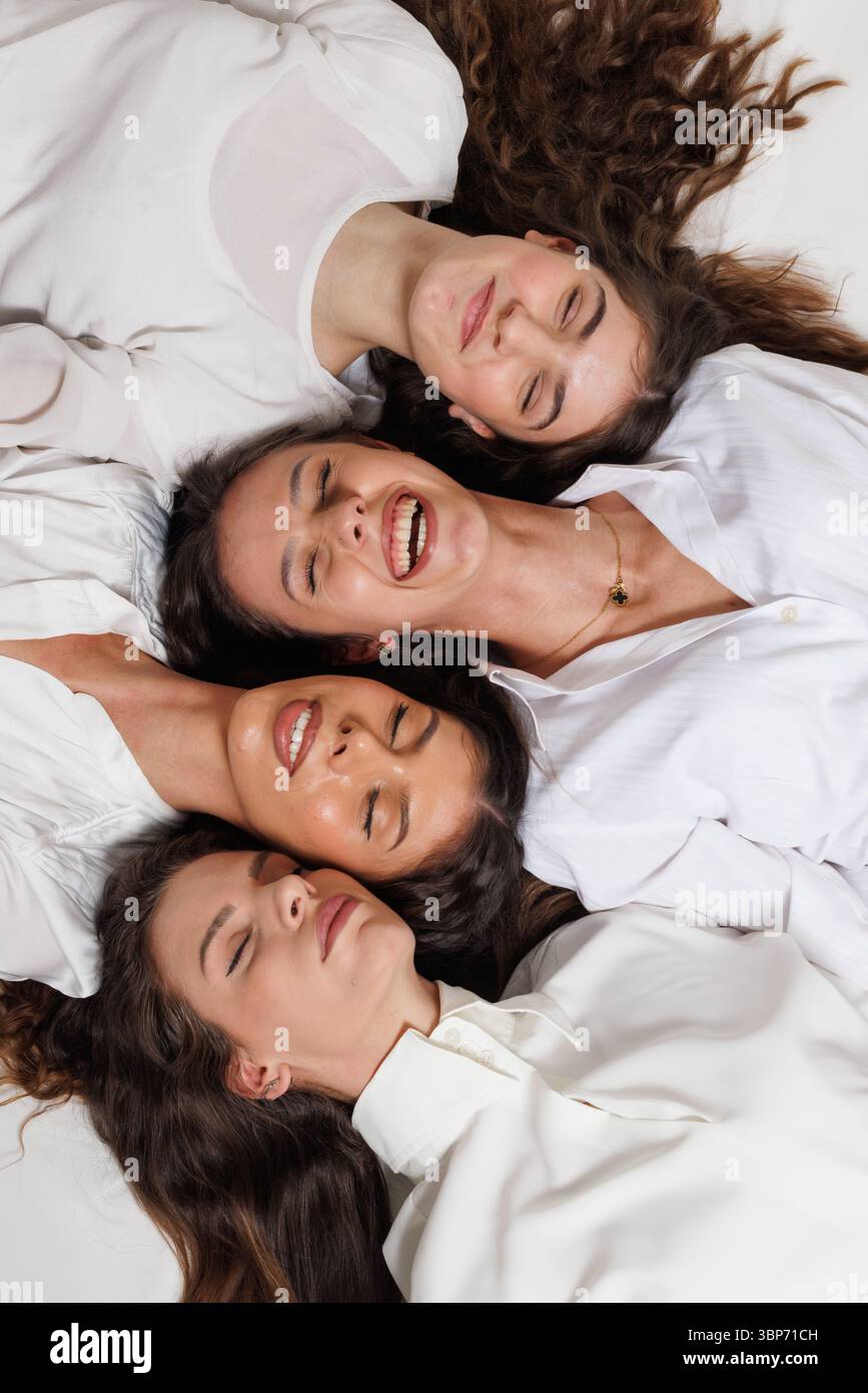 Group of women relaxing in a close circle, expressing happiness and ...
