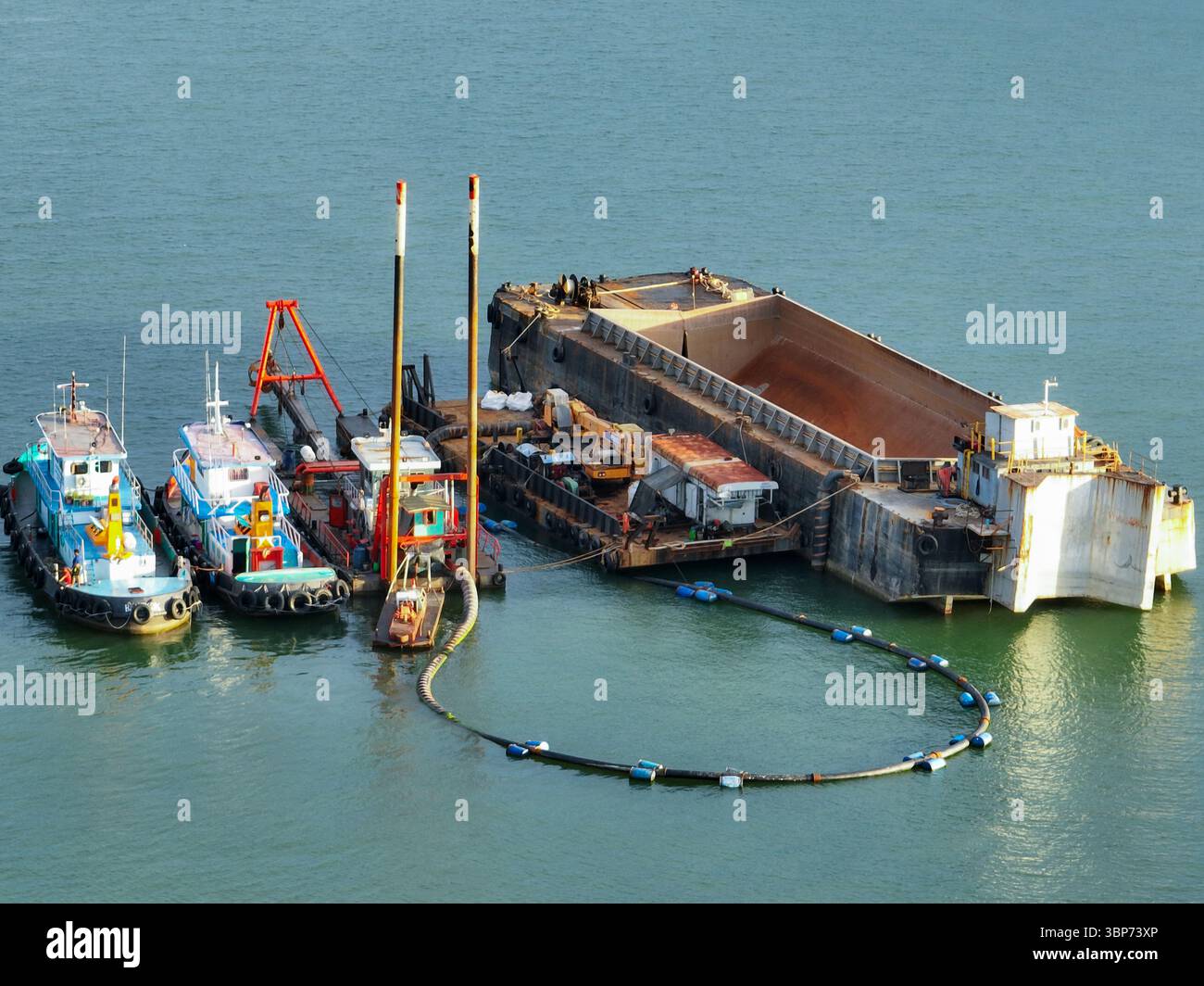 Heavy maritime engineering vessel conducting offshore dredging work ...