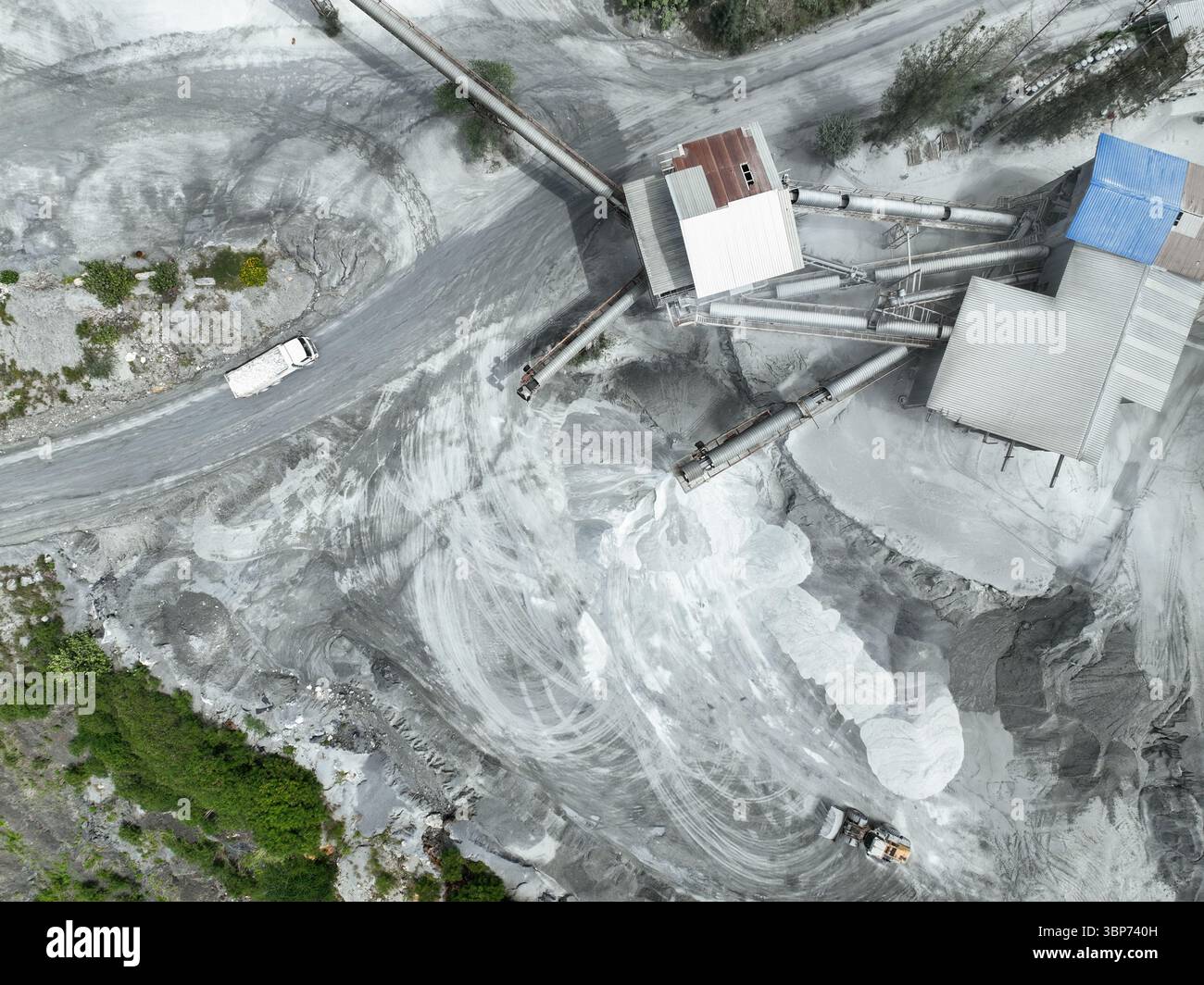 Aerial view of granite and limestone crushing plant with dump trucks ...