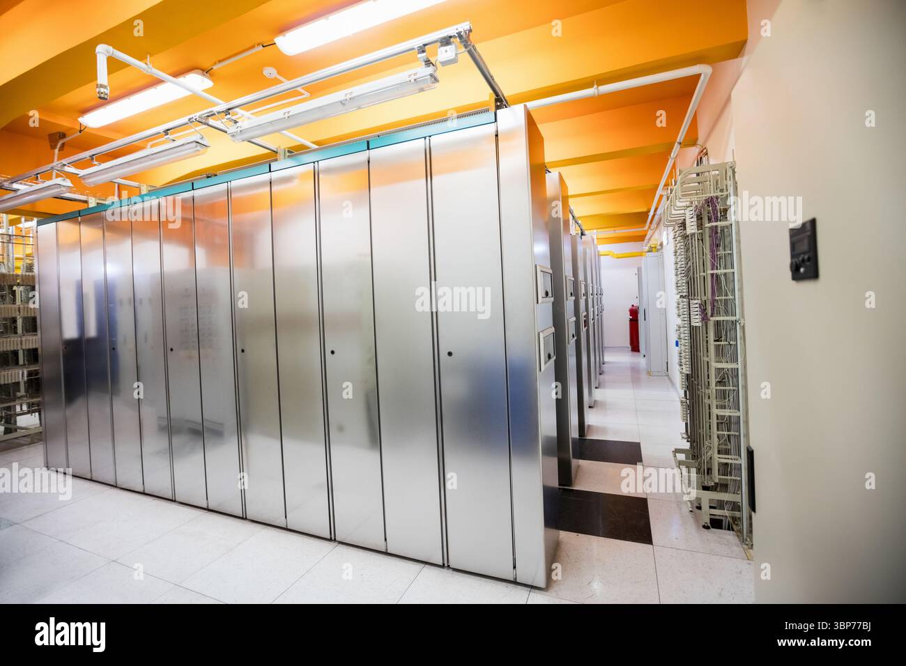 Server racks featuring cable trays, fluorescent lights, patch panel and extinguisher, flat ...