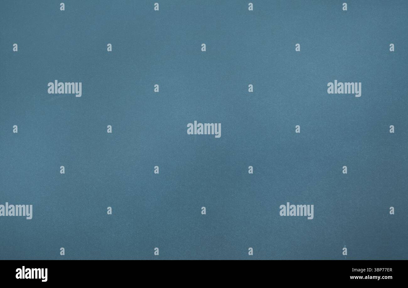 Textured blue fabric background is showing subtle shading and grainy ...