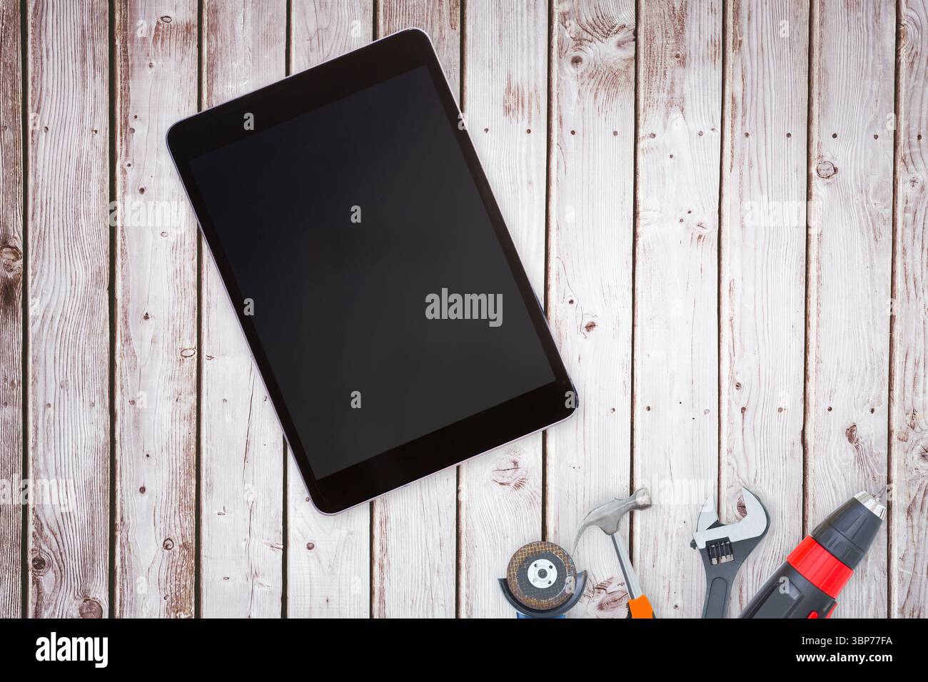 Tools and tablet on wooden background Stock Photo - Alamy