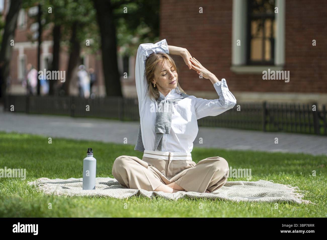 Conscious woman relaxing in nature, gaining strength, restoring ...