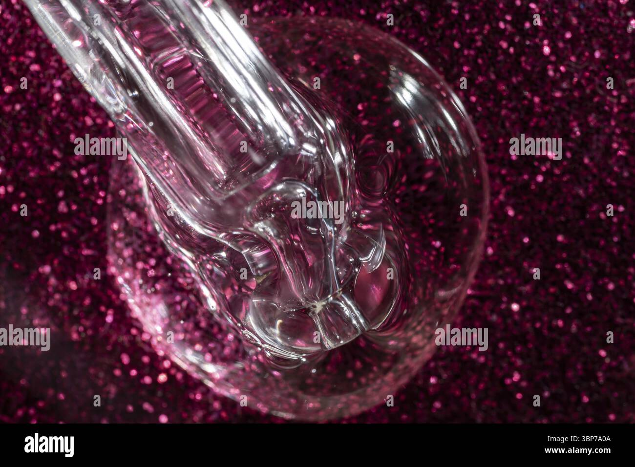 Transparent dropper liquid cosmetic texture. Macro, serum gel on a pink ...